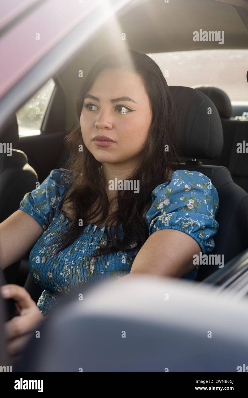 interior of vehicle with a woman driving, lifestyle of person working ...