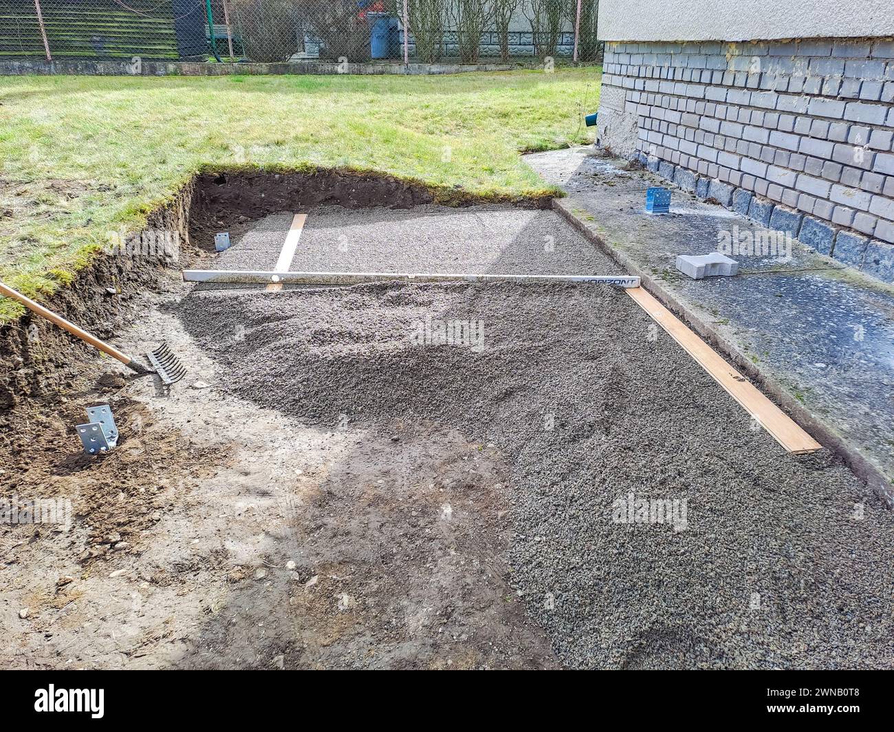 Laying gray concrete paving slabs in house courtyard driveway ...