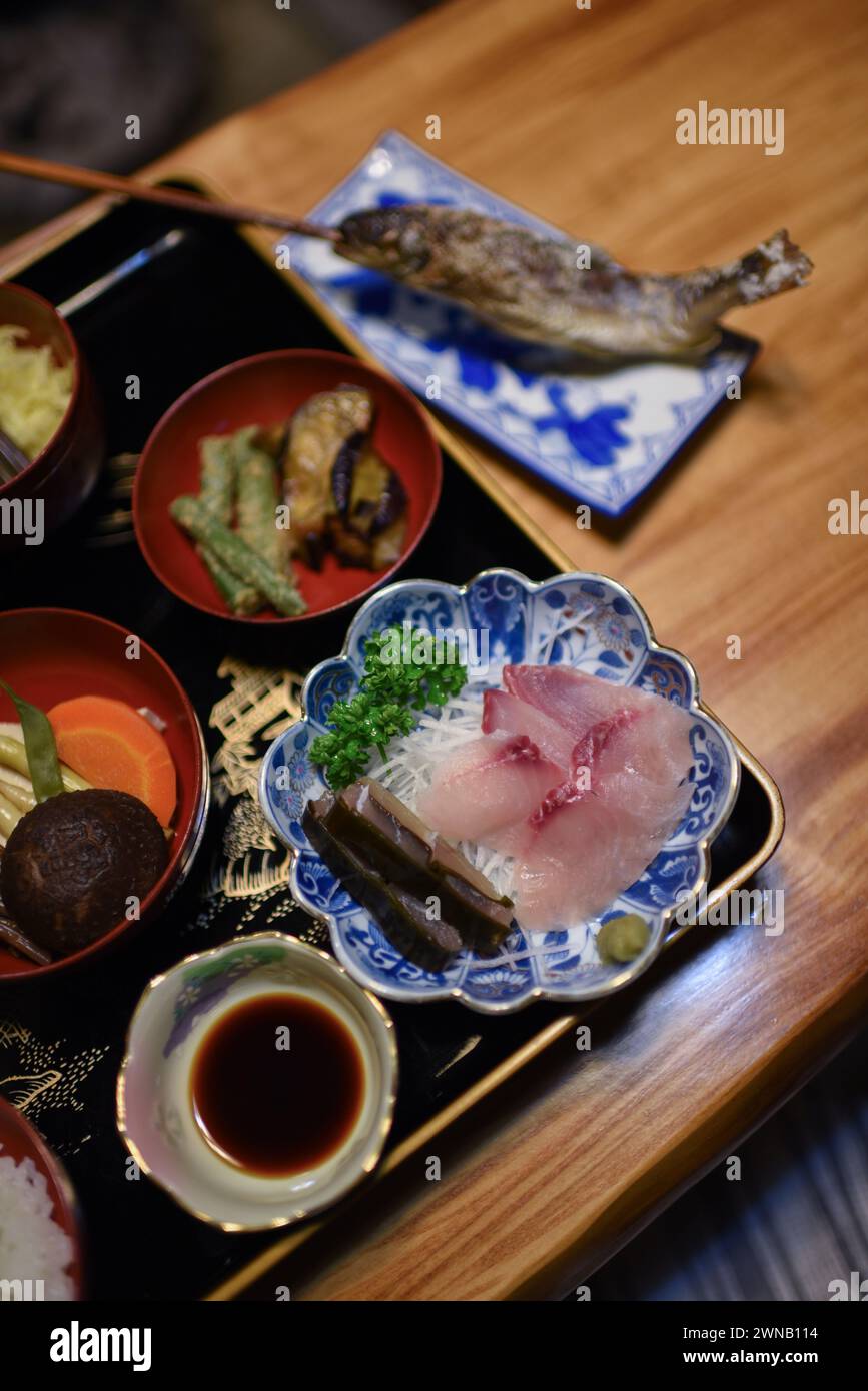 Dinner tray with assorted traditional Japanese food in Gassho Minshuku ...