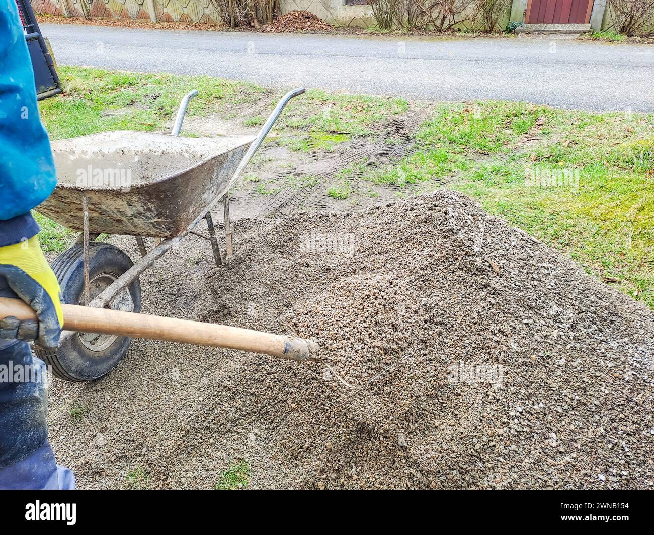 one large pile of gray rubble with a shovel and small stones in the ...