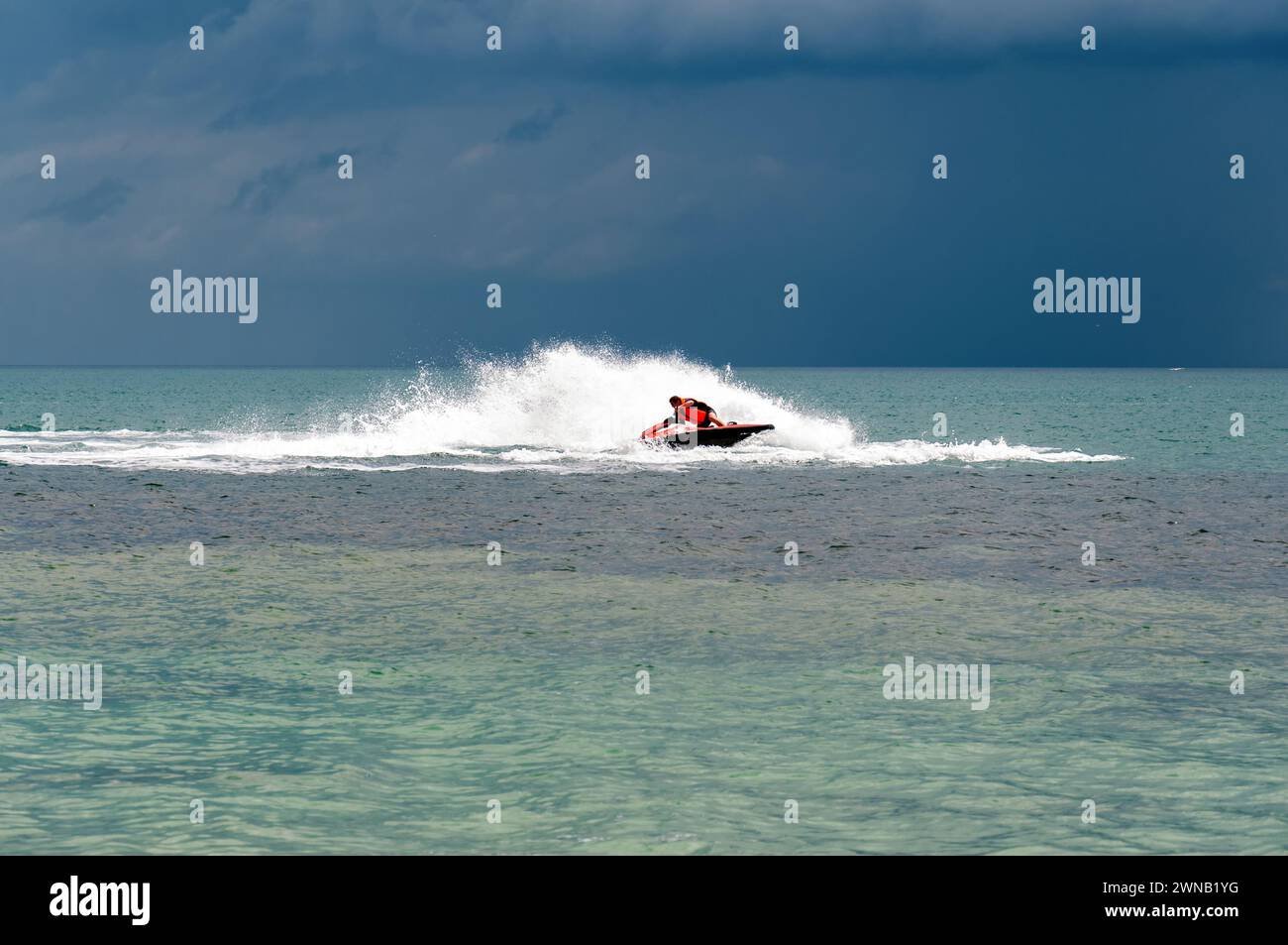The driver of the jet ski drives a jet ski at high speed, rides at ...