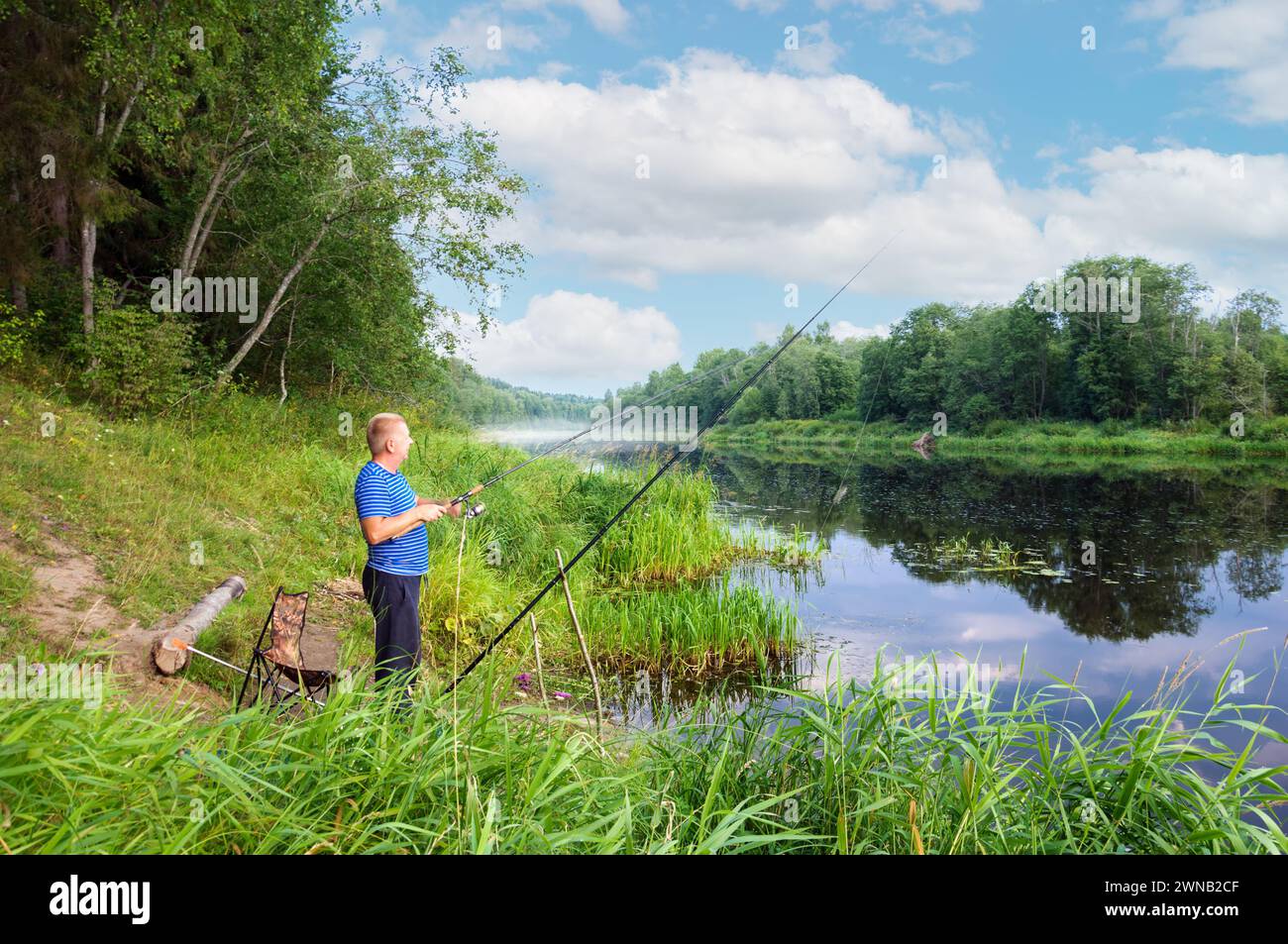 In the early summer morning, a fisherman is fishing in the upper ...