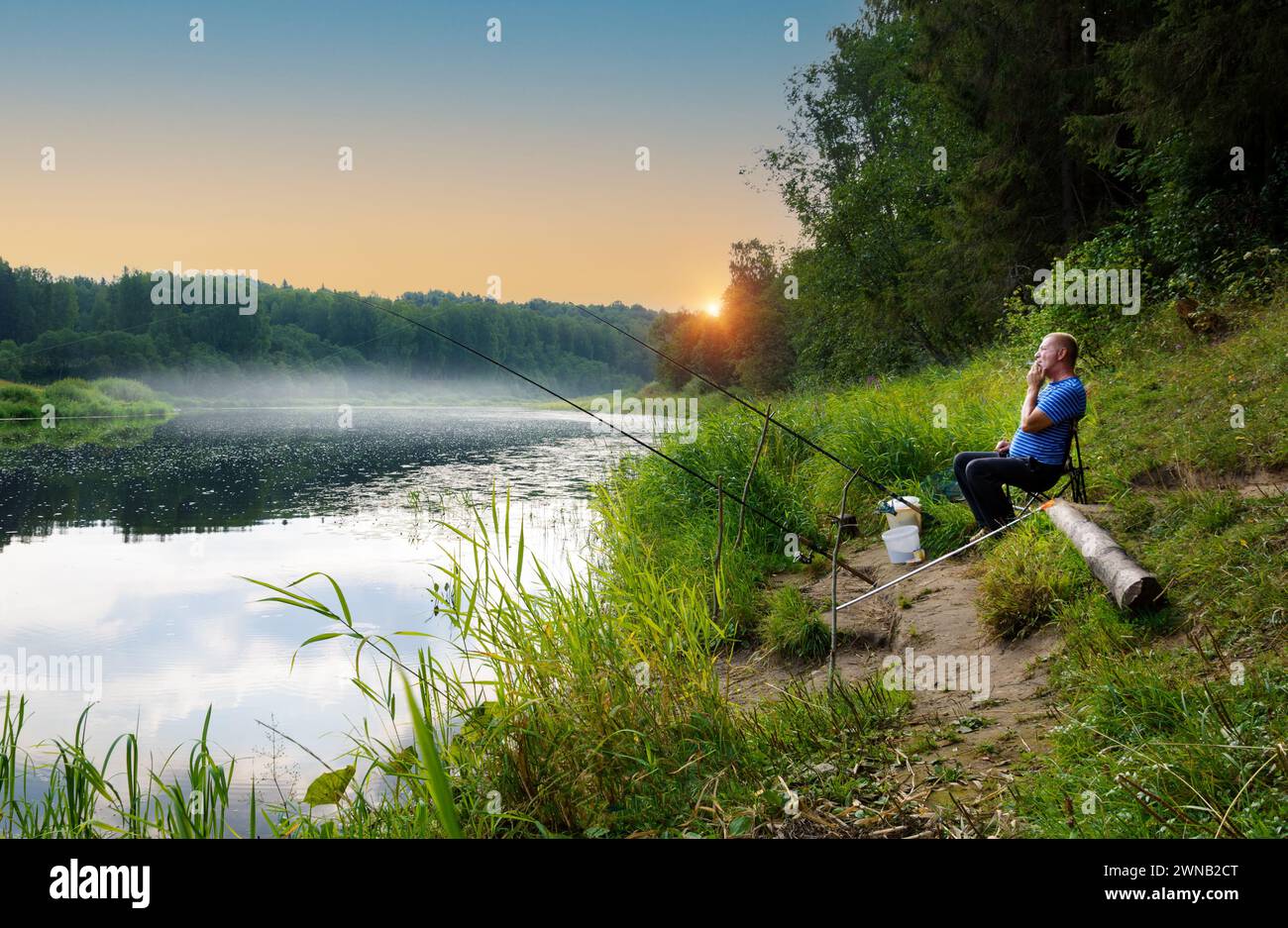 In the early summer morning, a fisherman is fishing in the upper ...