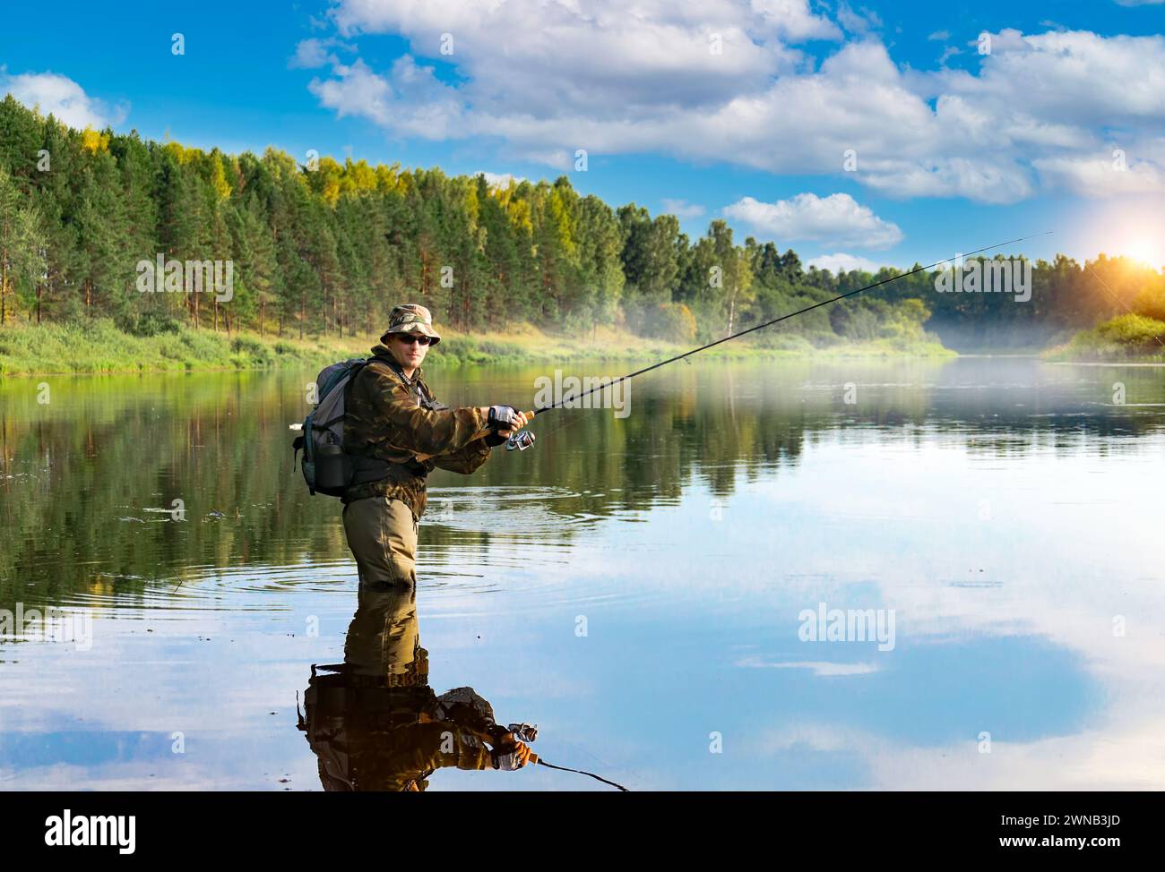 A fisherman is fishing in the Volga River. Russia, summer Stock Photo ...