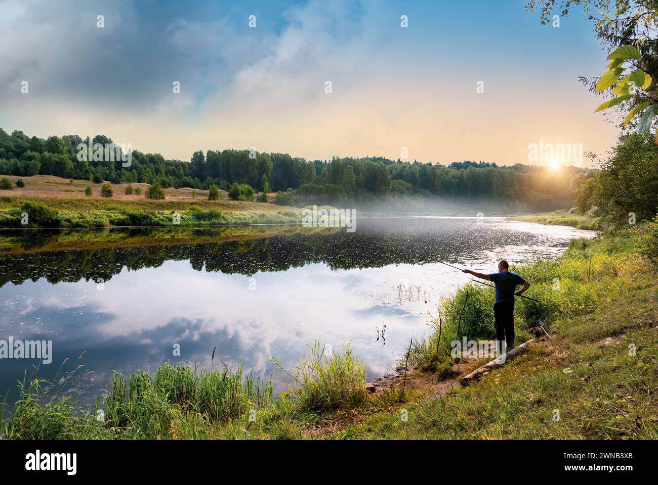 In the early summer morning, a fisherman is fishing in the upper ...