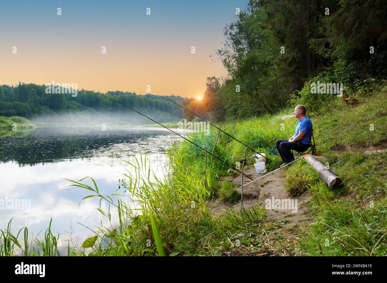 In the early summer morning, a fisherman is fishing in the upper ...