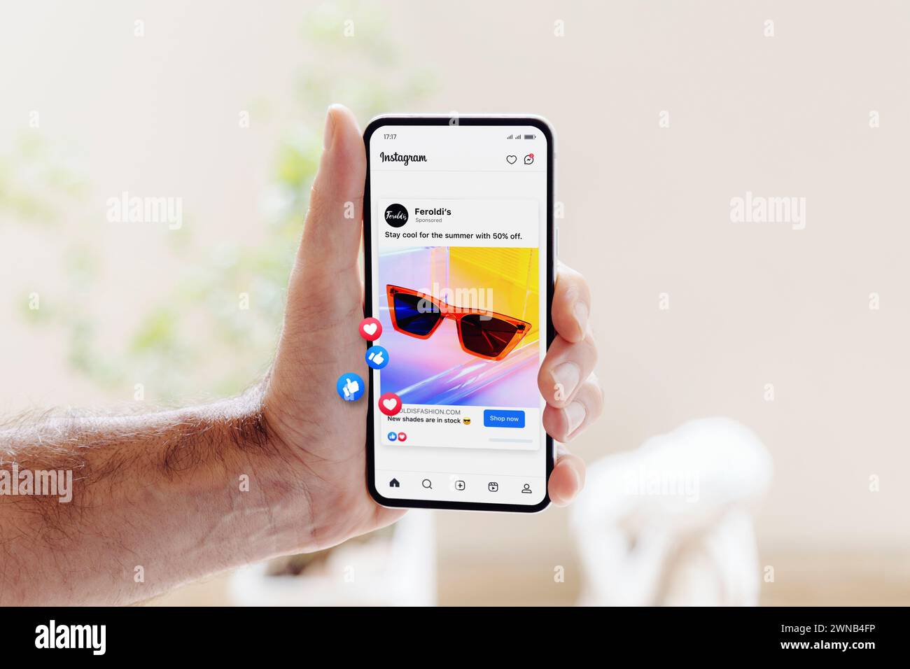 Meta ads on mobile phone screen. Man holding smartphone showing ...