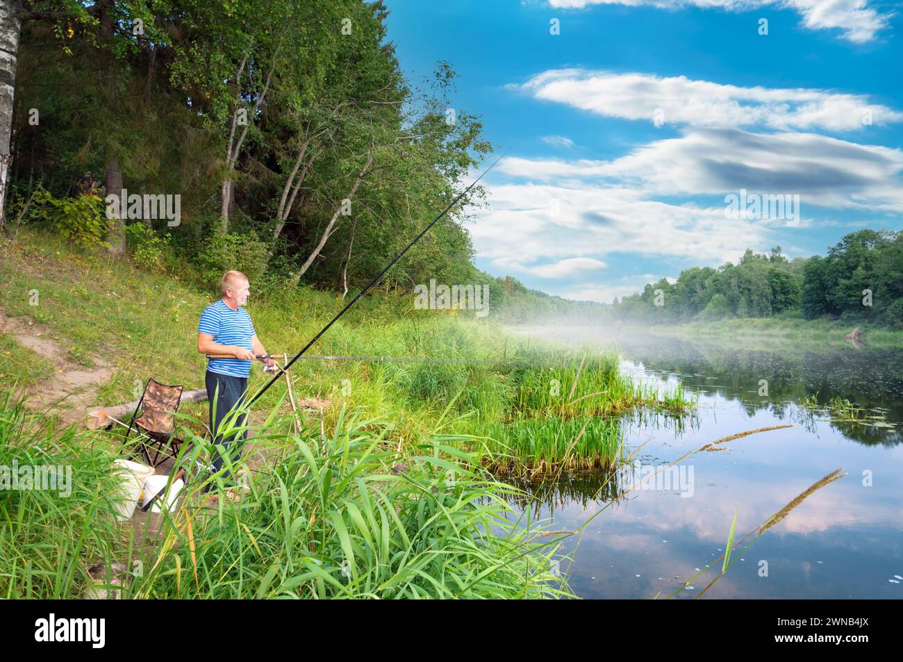 In the early summer morning, a fisherman is fishing in the upper ...