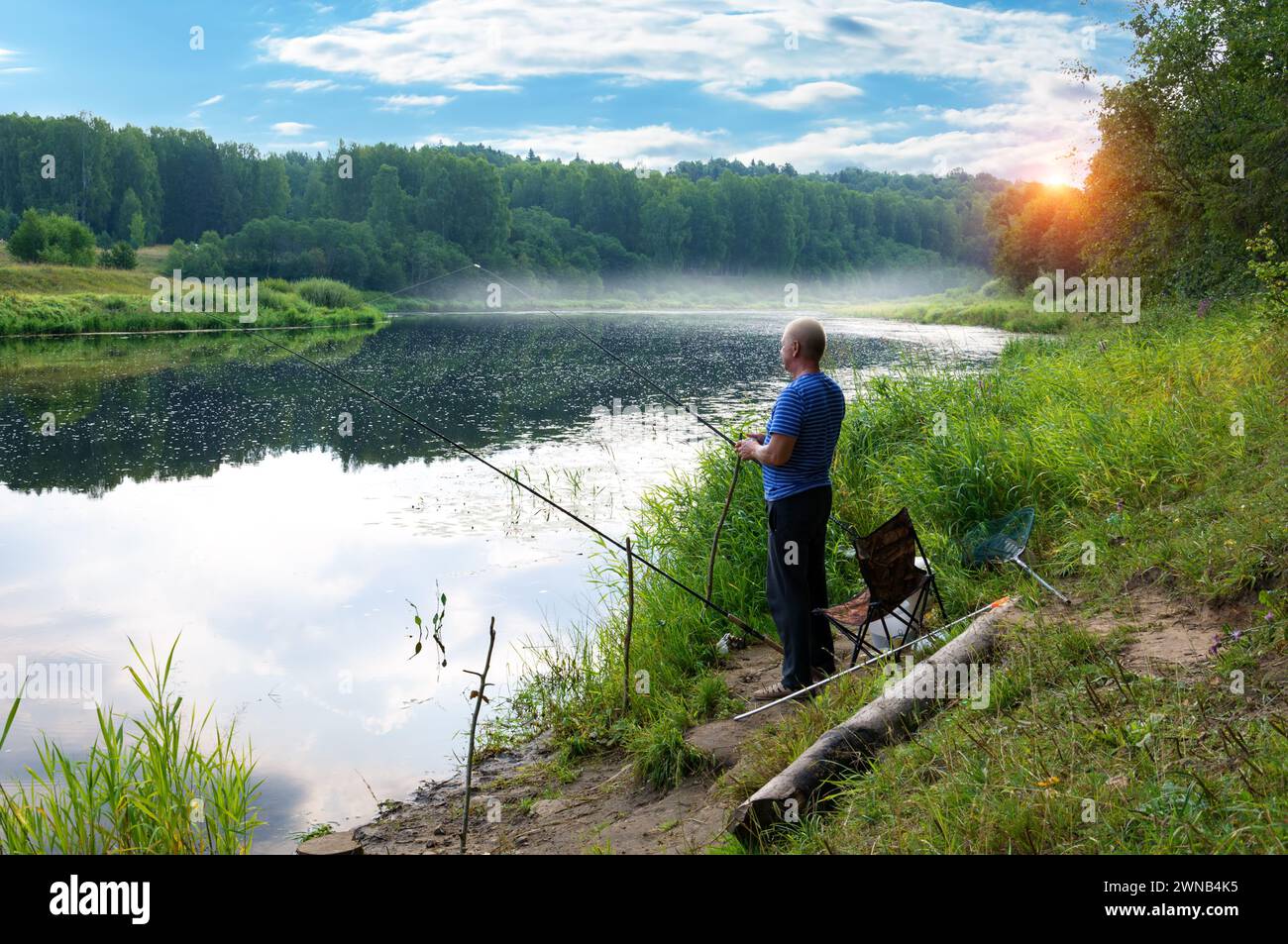 In the early summer morning, a fisherman is fishing in the upper ...