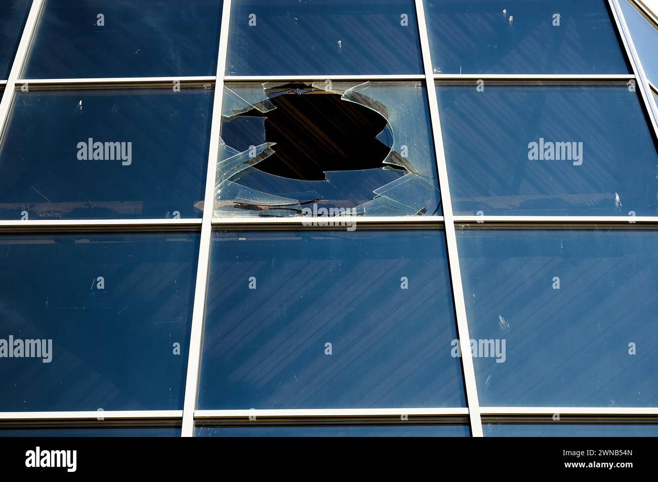 Broken office window Stock Photo - Alamy