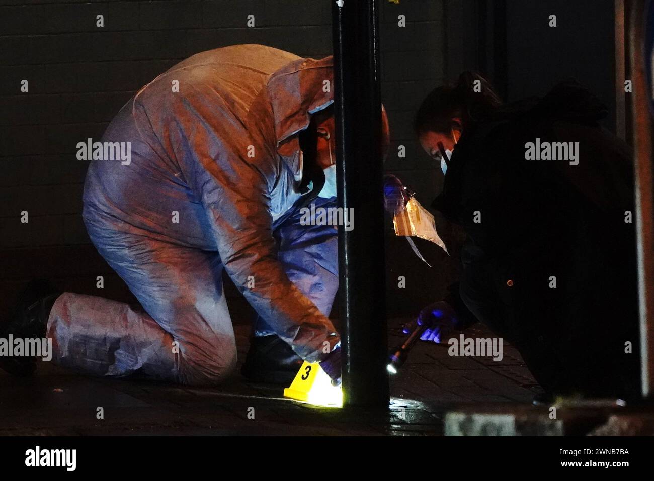A forensic officer at the scene of a shooting in Clapham, London. Three ...