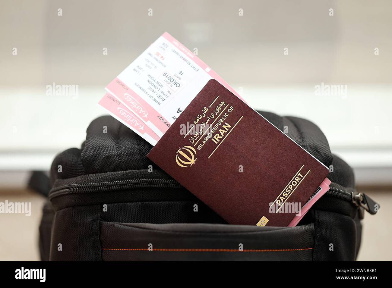 Red Islamic Republic of Iran passport with airline tickets on touristic ...