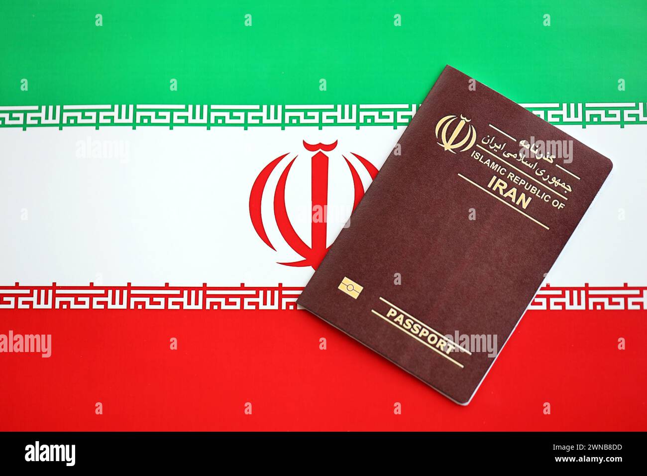 Red Islamic Republic of Iran passport on national flag background close ...