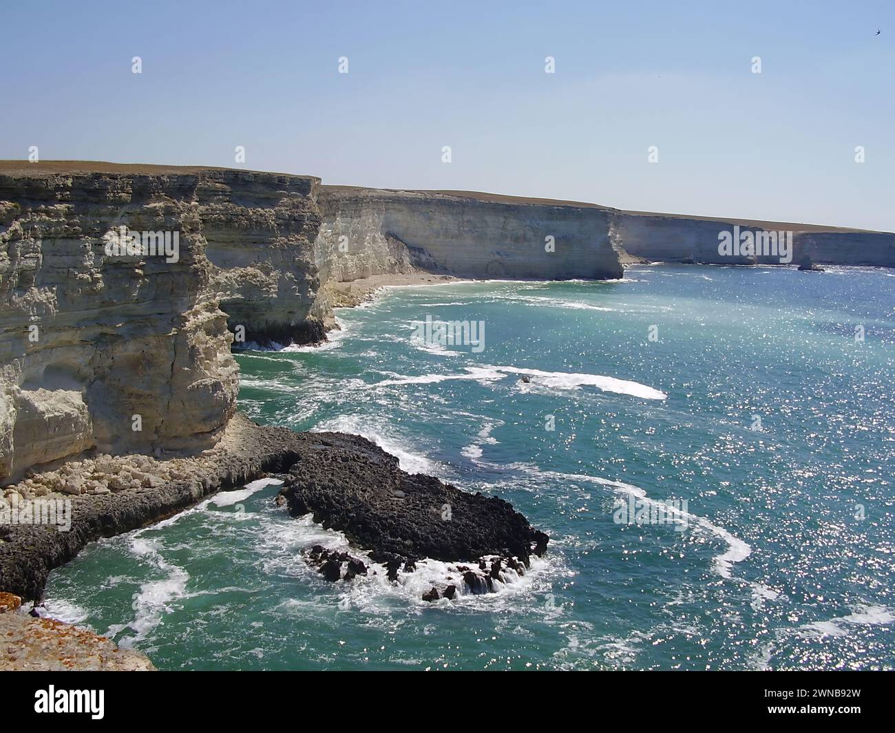 Powerful ocean waves meet a dramatic rocky coastline, creating a ...