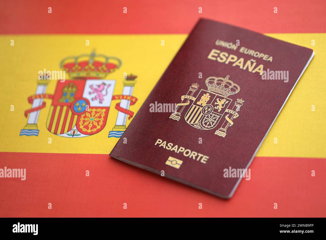 Red Spanish passport of European Union on national flag background ...