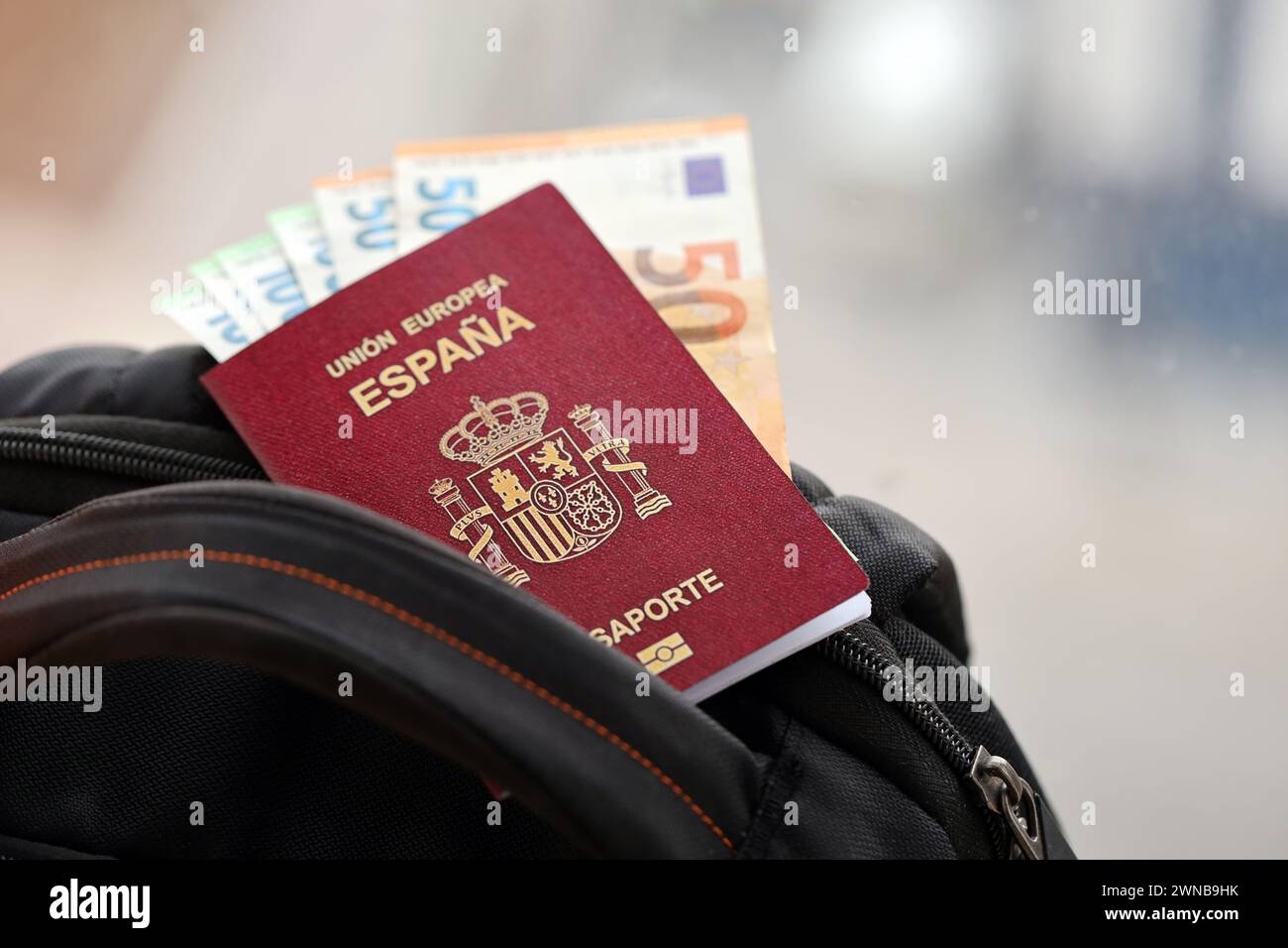 Red Spanish passport of European Union with money and airline tickets ...
