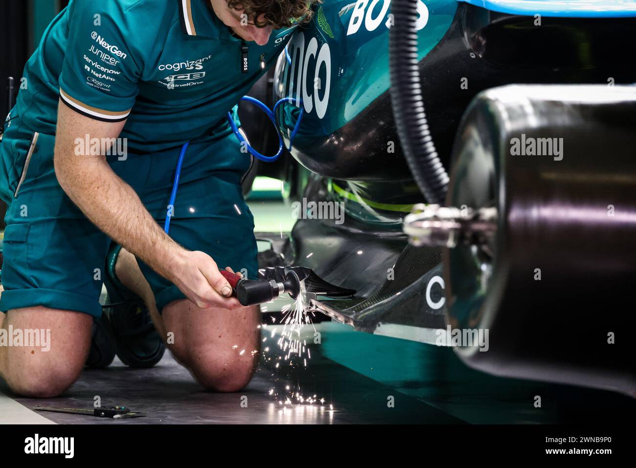 Aston Martin F1 Team AMR23, mechanical detail of a mechanic working on ...