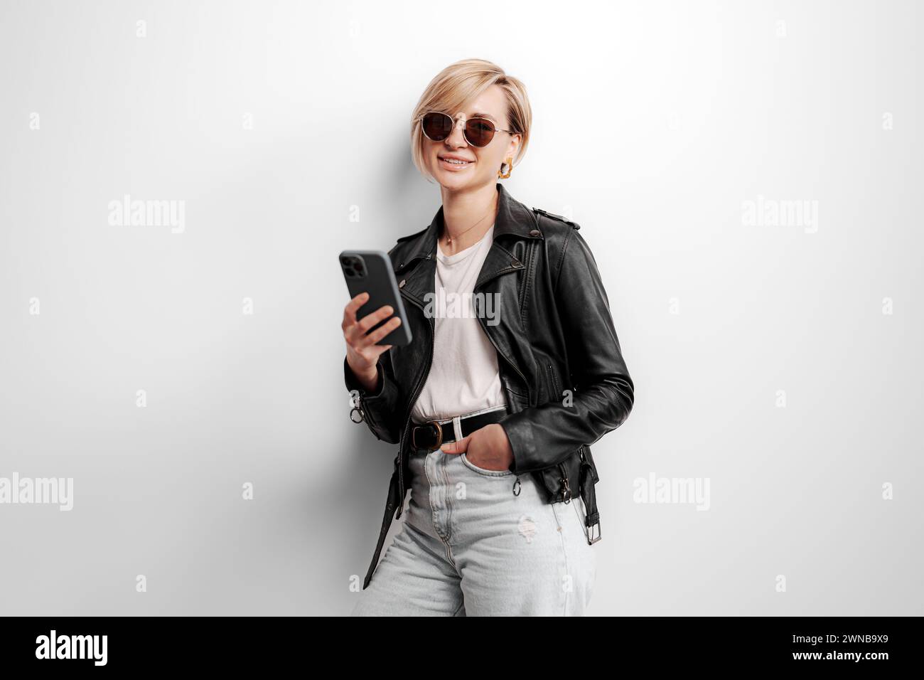 Tech-Savvy Style in Leather and Denim Stock Photo - Alamy