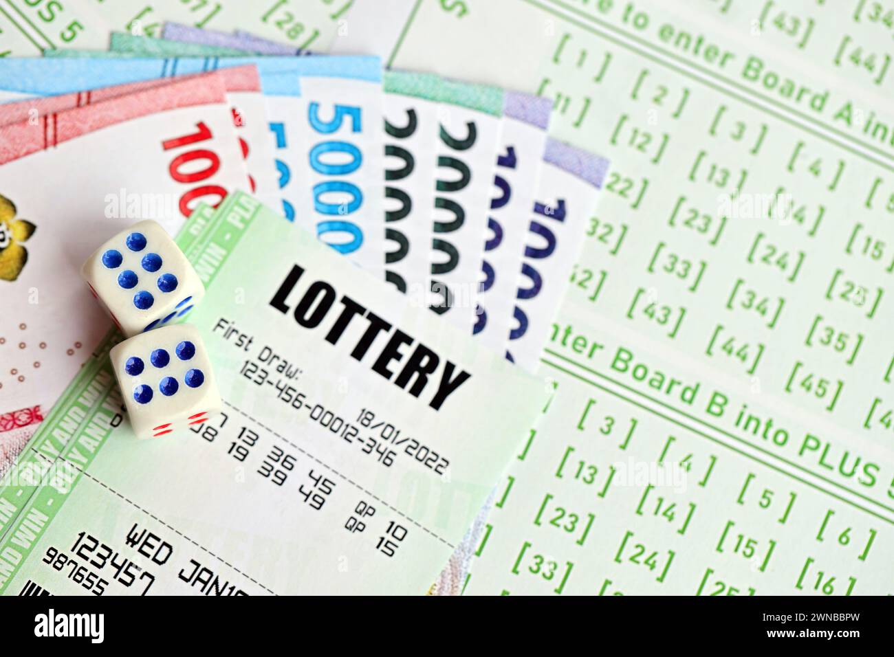 Green lottery tickets and indonesian money bills on blank with numbers ...