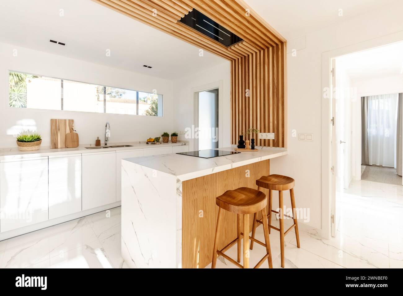 an image of American style open kitchen wooden features and marble ...