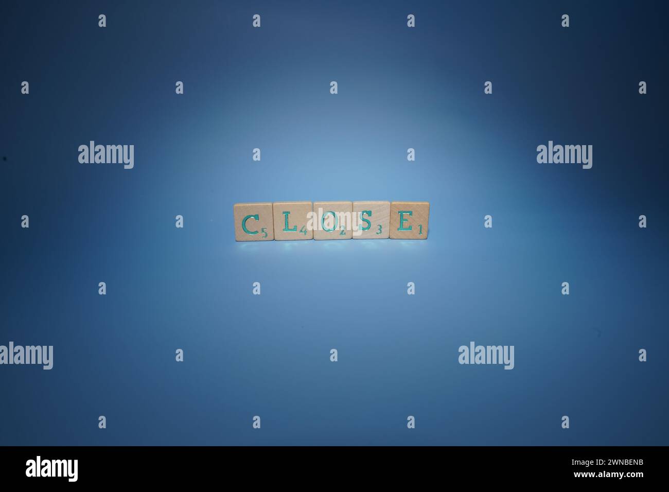 The Wooden letters spell close against a blue backdrop Stock Photo - Alamy