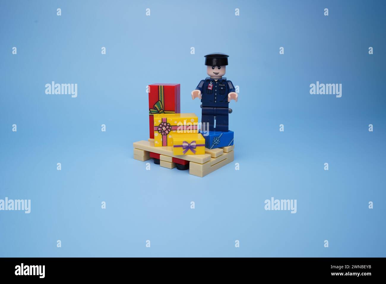 A Lego policeman isolated against an empty blue background Stock Photo ...