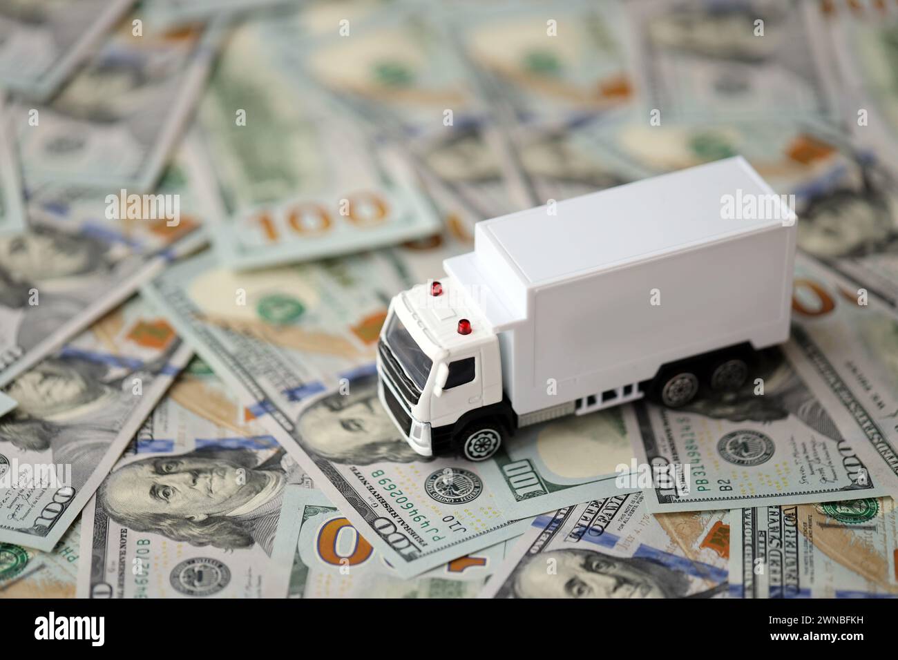 Delivery truck on hundred dollar bills banknotes. Background of moving ...
