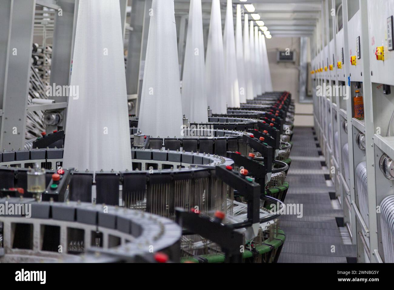 Interior of a factory shop. A series of equipment for weaving ...