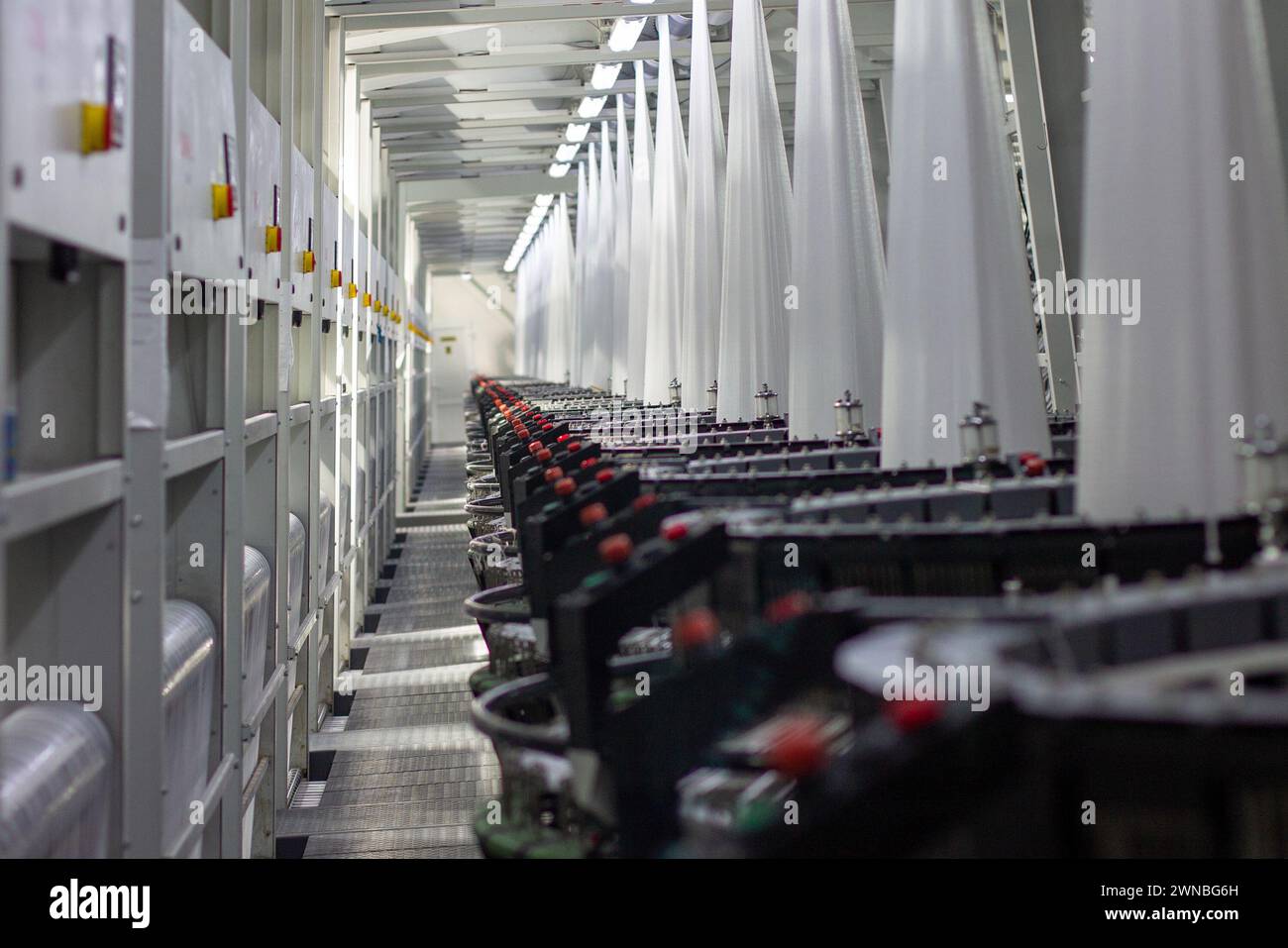 Interior of a factory shop. A series of equipment for weaving ...