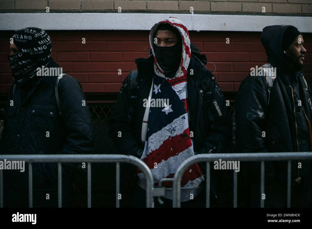 A migrant wearing a sweatshirt in colors of the American flag seen ...