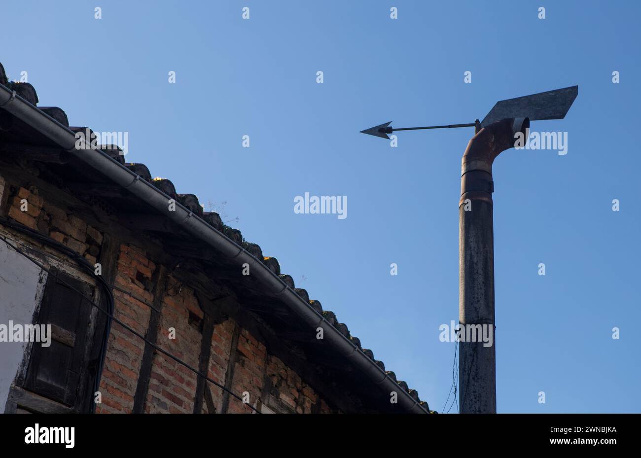 Domestic wind directional chimney cap equipped with arrow. Blue sky ...