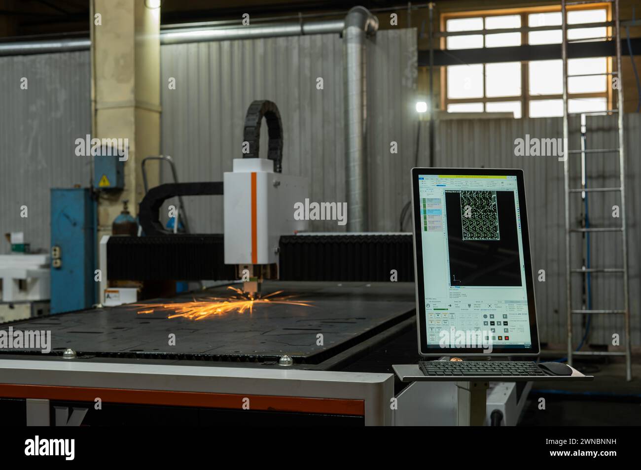 CNC machine. Laser cutting of metal. Sparks Stock Photo - Alamy