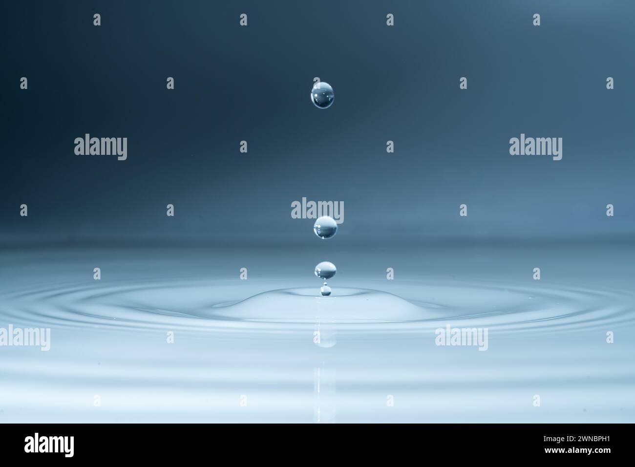 Close-up of a water drop and splash background, small impact causes big ...