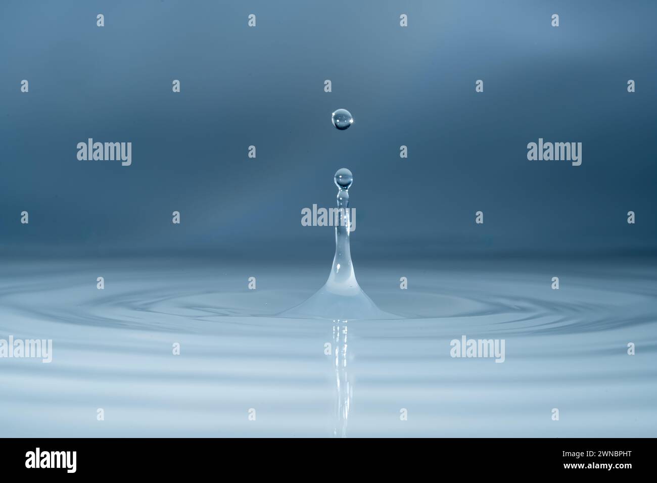 Close-up of a water drop and splash background, small impact causes big ...