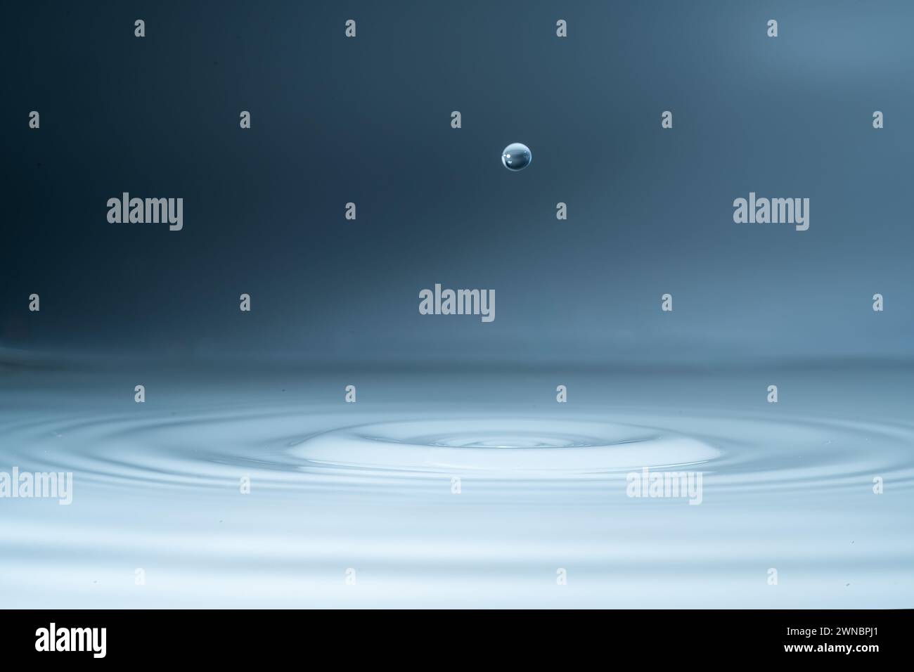 Close-up of a water drop and splash background, small impact causes big ...