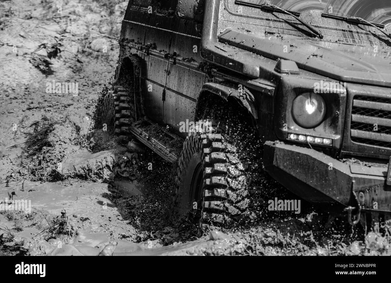 Off-road travel on mountain road. Bottom view to big offroad car wheel ...