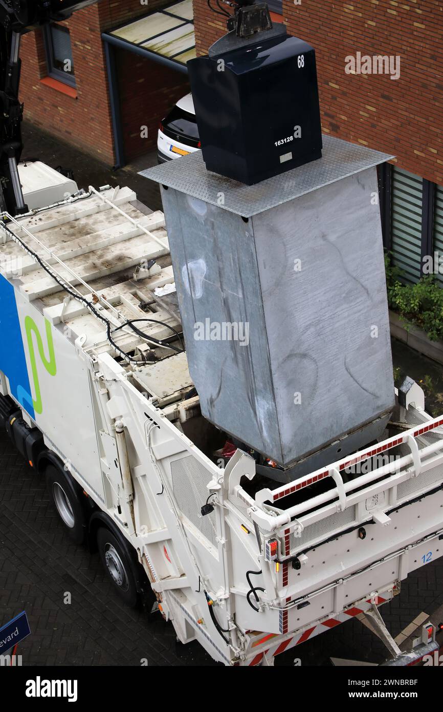 Underground residual waste containers being emptied by the municipal ...