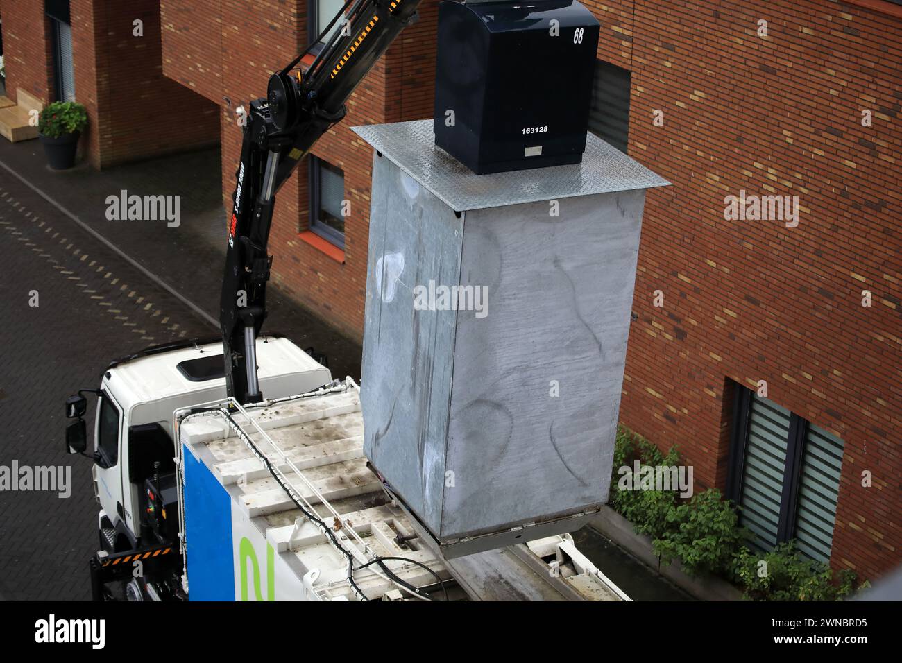Underground residual waste containers being emptied by the municipal ...