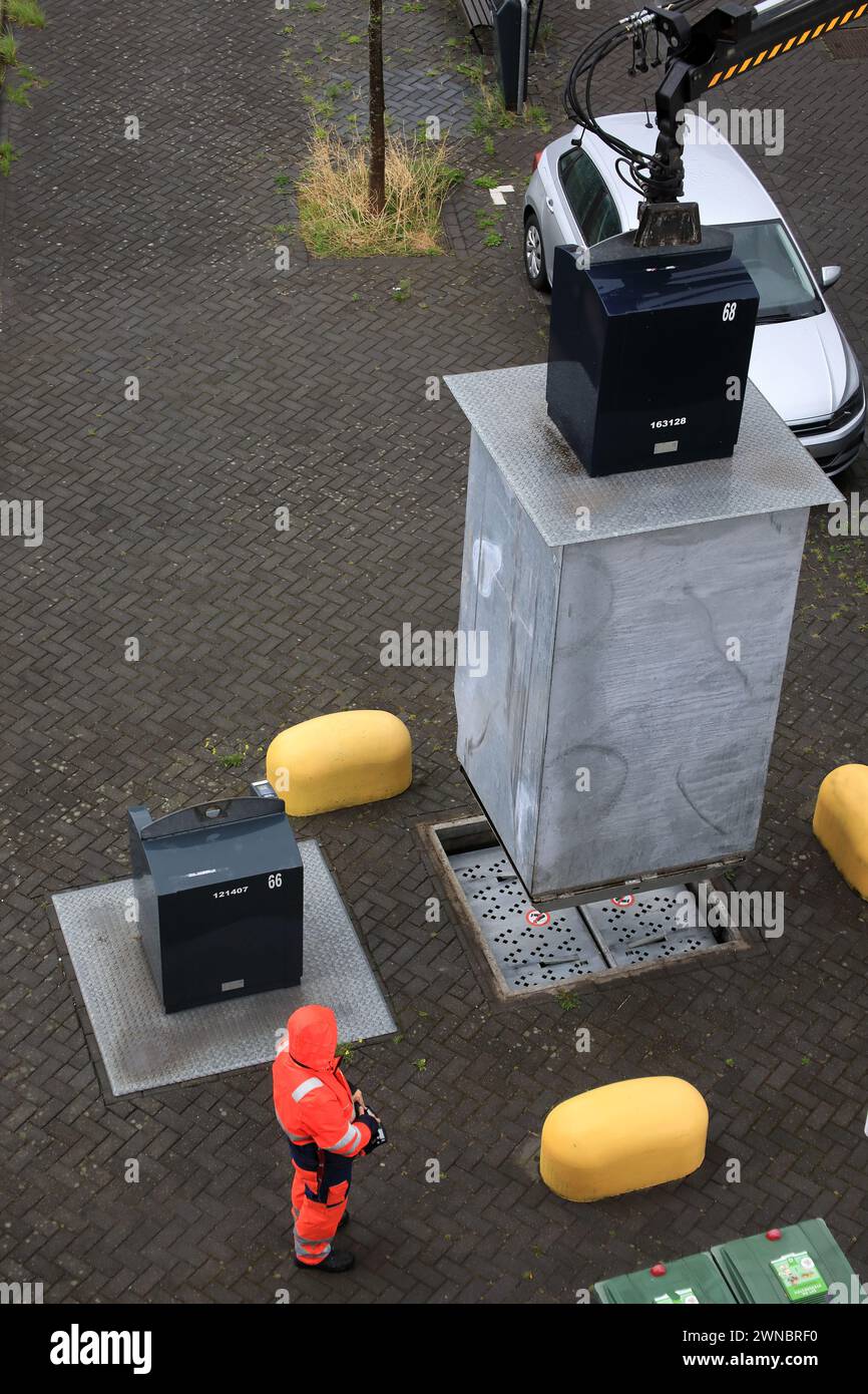 Underground residual waste containers being emptied by the municipal ...
