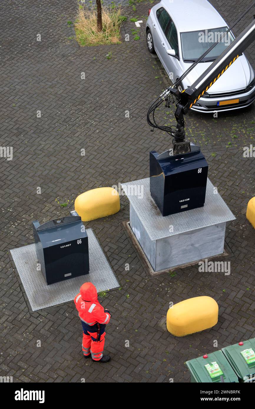 Underground residual waste containers being emptied by the municipal ...