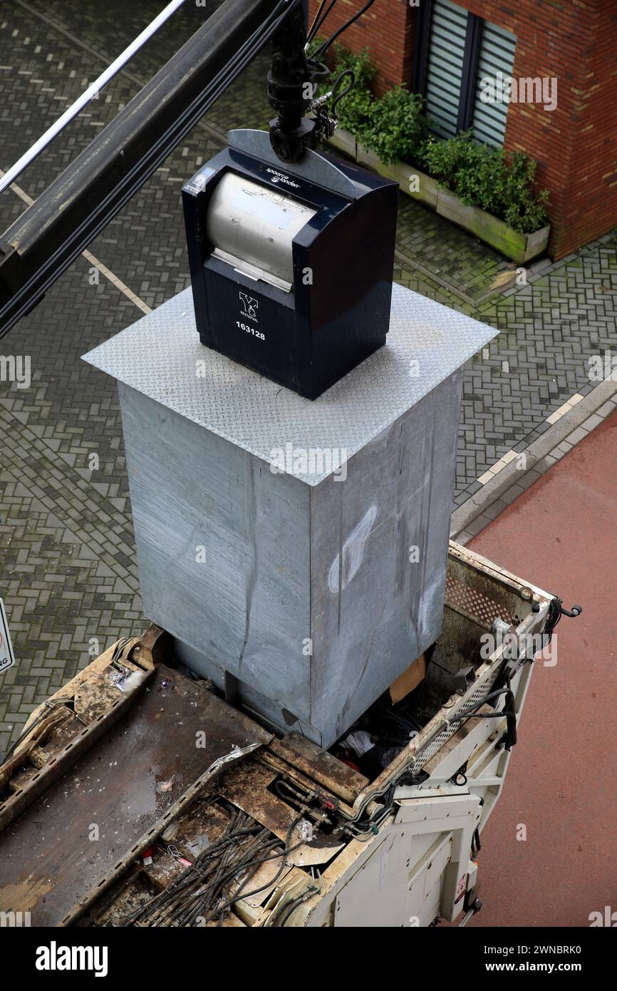 Underground residual waste containers being emptied by the municipal ...