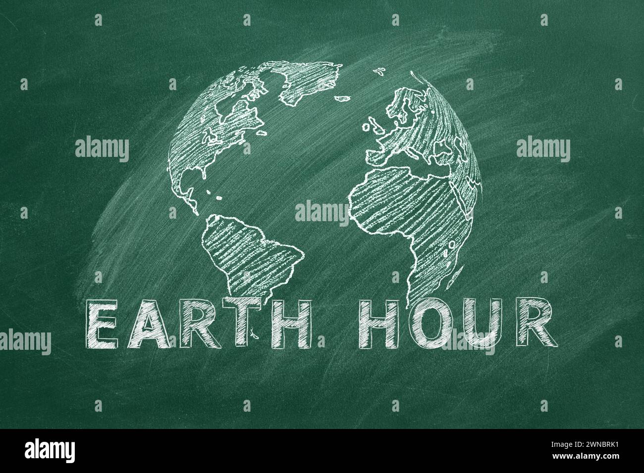 Rotating globe with lettering EARTH HOUR hand drawn in chalk on a ...