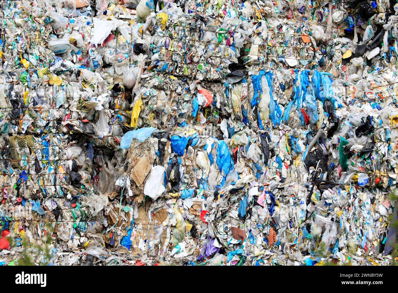 Aerial view of a large collection of stacked plastic scraps at an ...