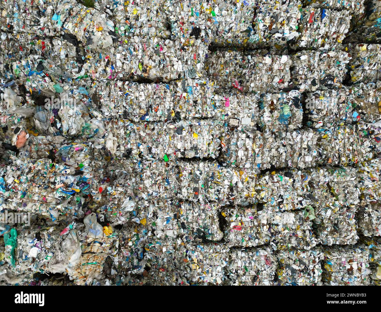 Aerial view of a large collection of stacked plastic scraps at an ...