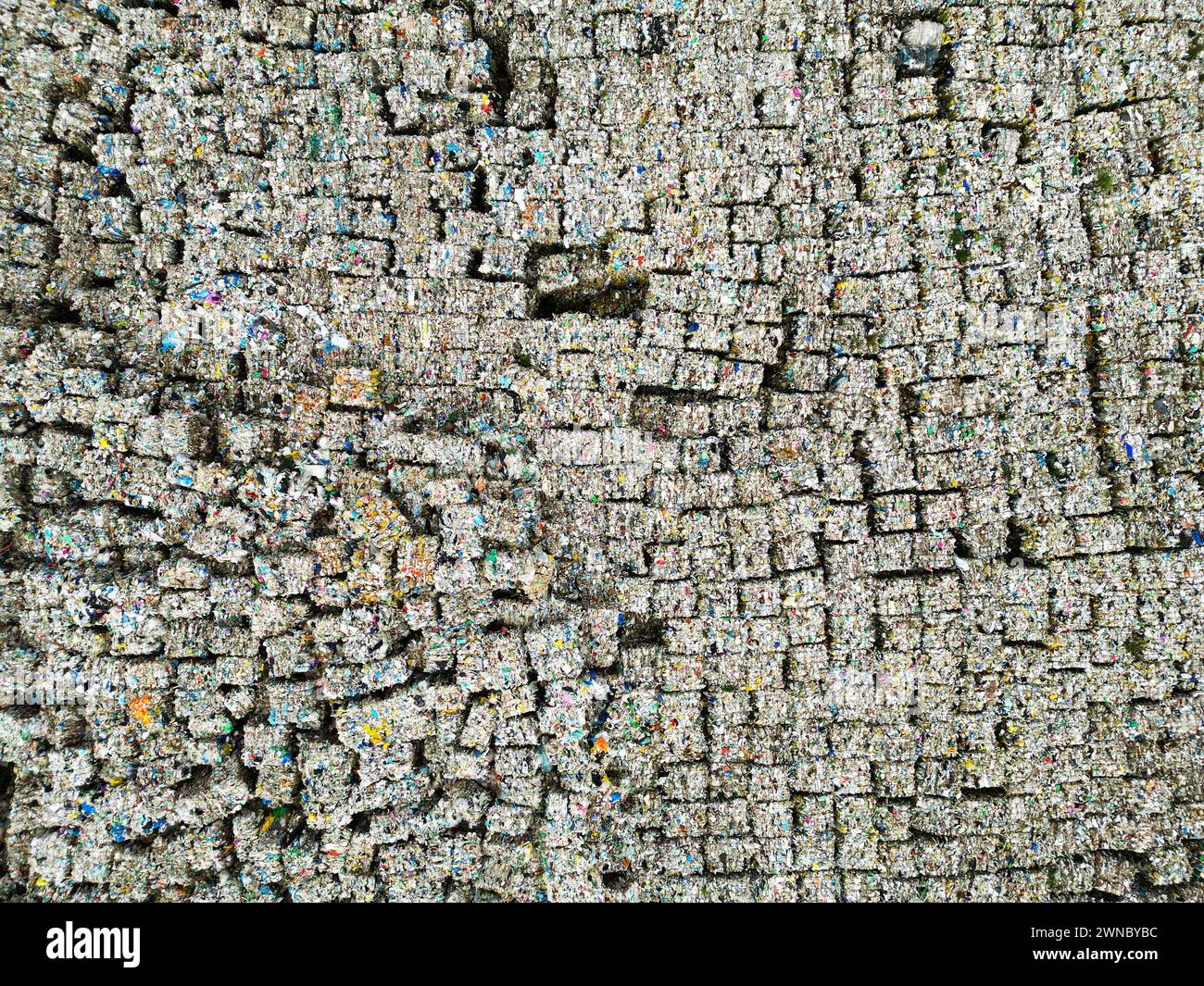 Aerial view of a large collection of stacked plastic scraps at an ...