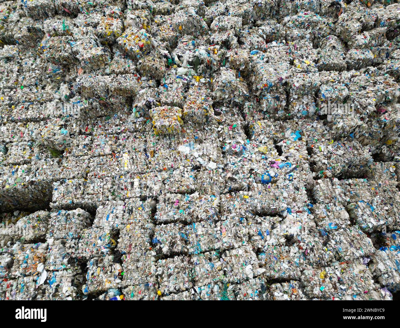 Aerial view of a large collection of stacked plastic scraps at an ...