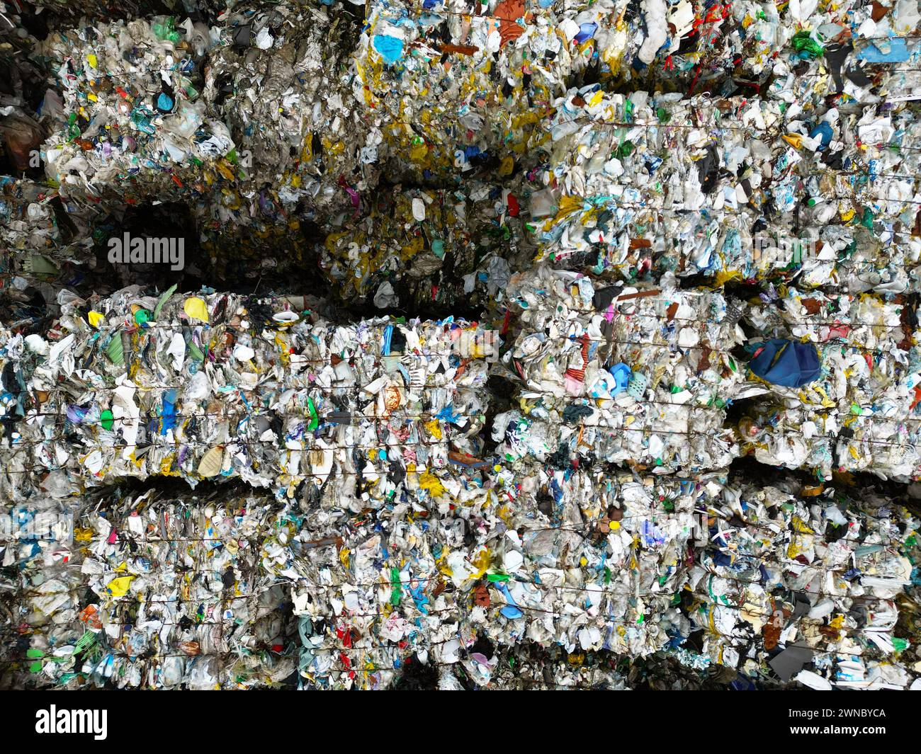 Aerial view of a large collection of stacked plastic scraps at an ...