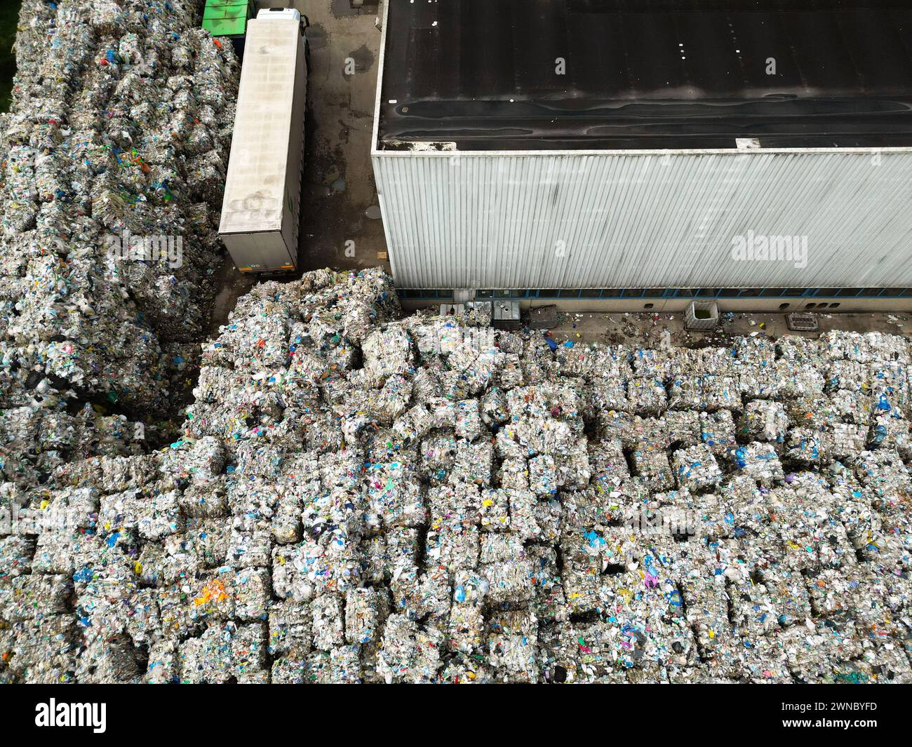 Aerial view of a large collection of stacked plastic scraps at an ...