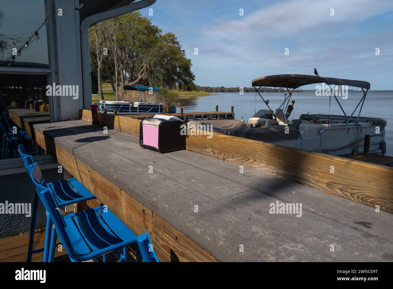 Restaurant bar on lake with pontoon boat in Florida Stock Photo - Alamy