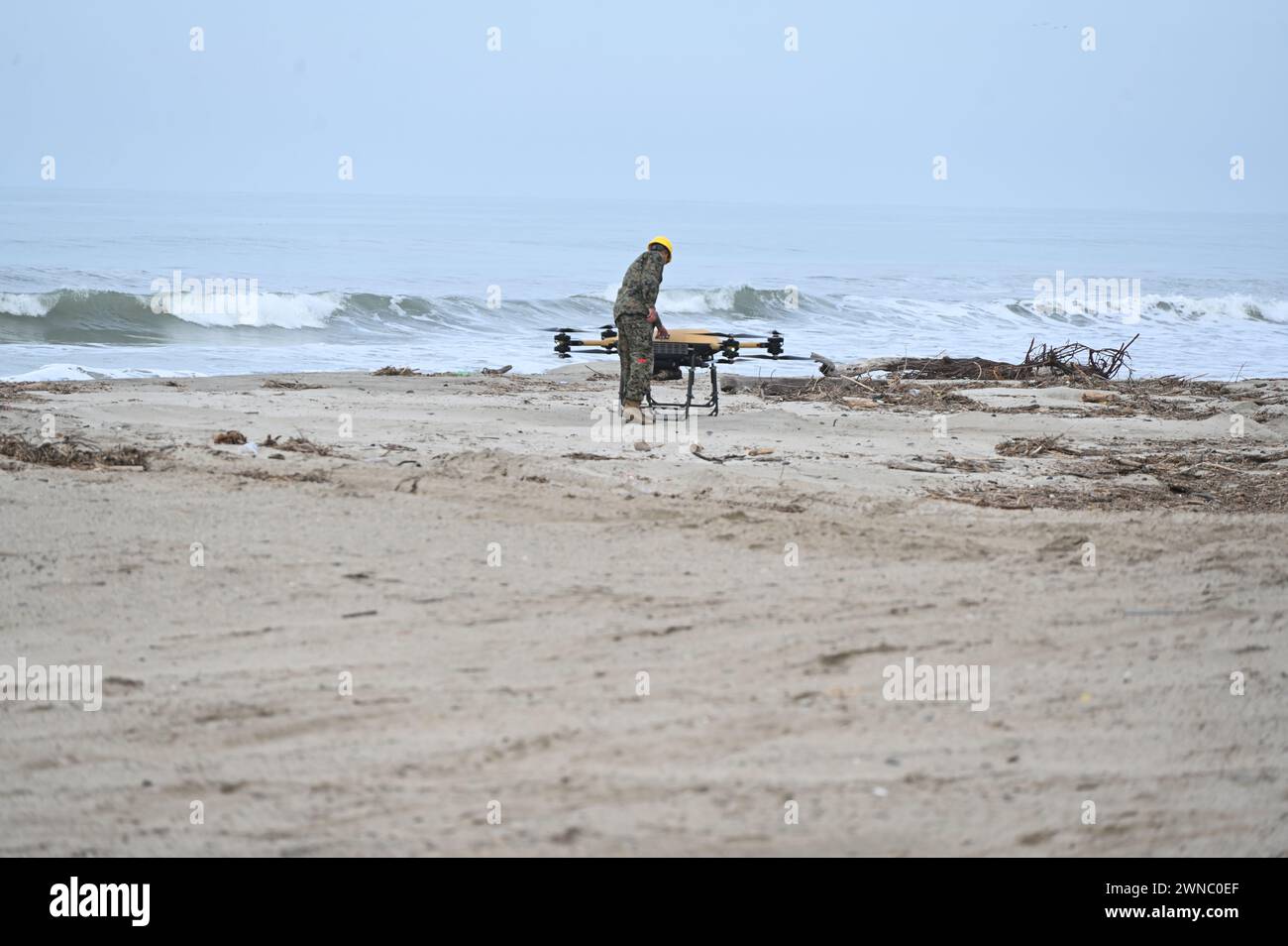 A Marine, alongside U.S. Army civilians assigned to the Army ...